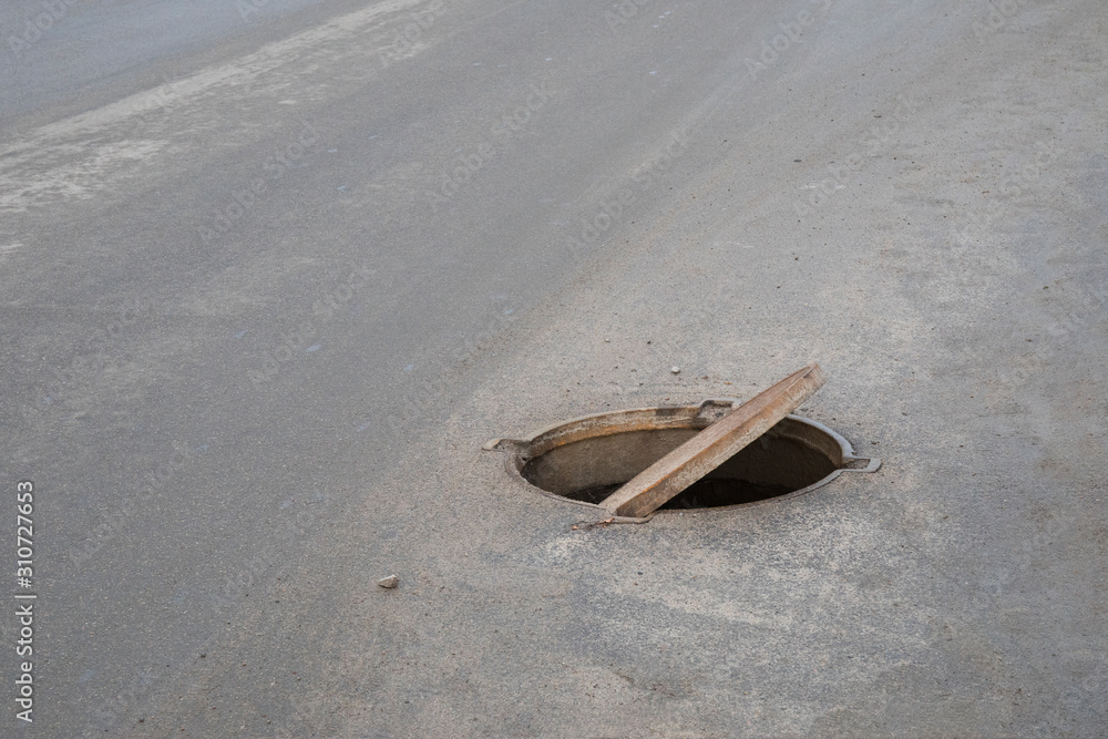 Dangerous opened manhole cover, opened sewerage hatch it the middle of ...