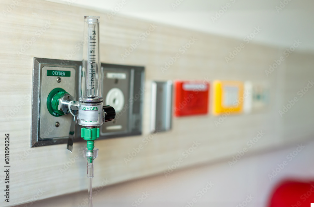 Oxygen flow meter plugged in the green outlet on hospital wall, Medical ...