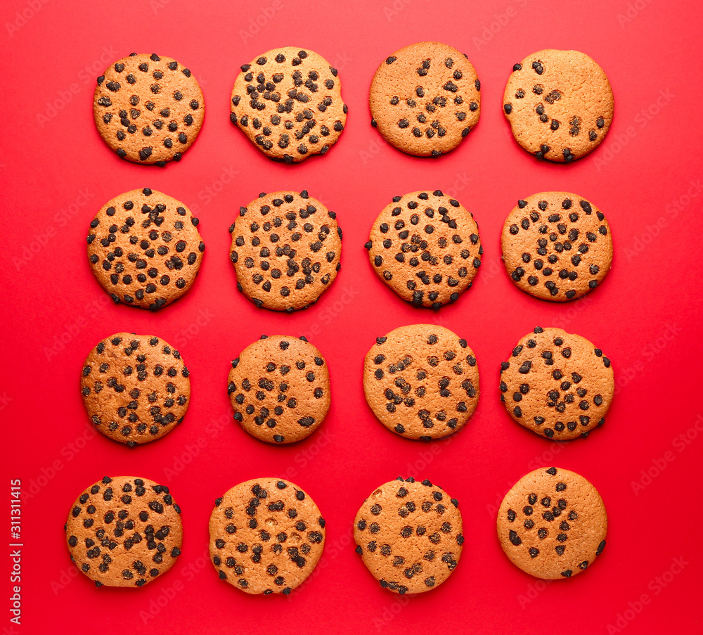 Tasty cookies with chocolate chips on color background Stock Photo ...