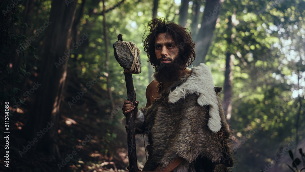 Portrait of Primeval Caveman Wearing Animal Skin and Fur Hunting with a ...