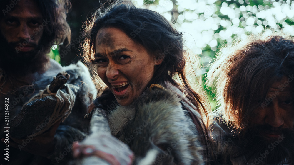 Female Leader and Two Primeval Cavemen Warriors Threat Enemy with Stone ...