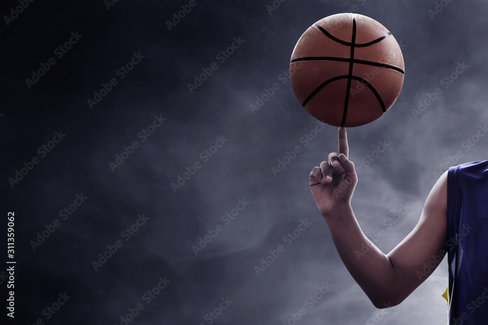 Basketball player spinning a ball Stock Photo | Adobe Stock