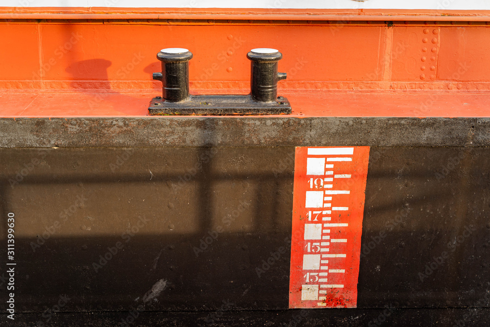 Water level measurement gauge on a ship wall with two bollards Stock ...