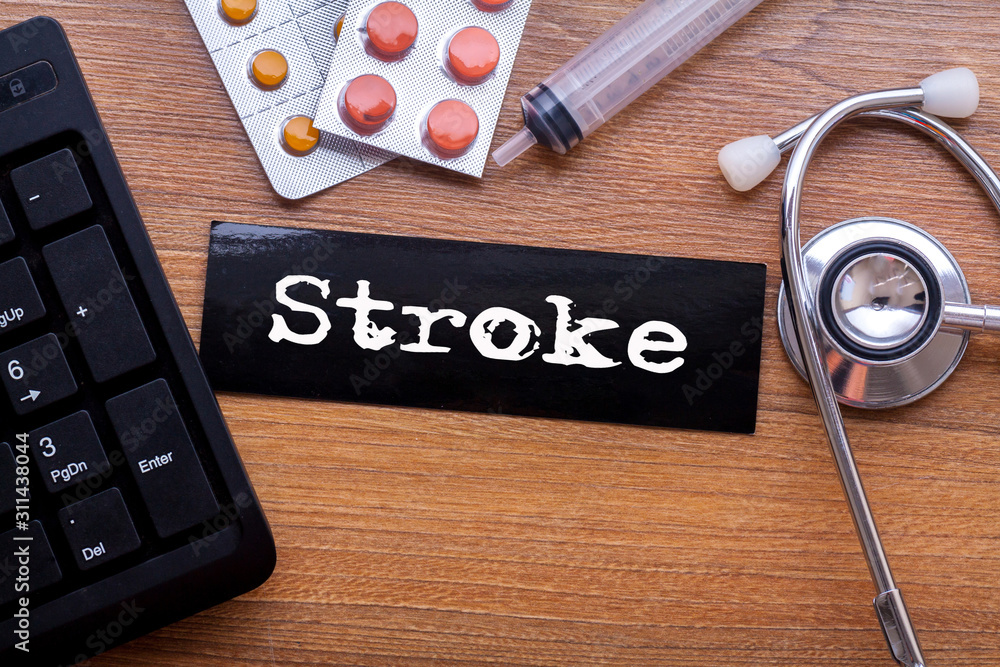 Stroke words written on label tag with medicine,syringe,keyboard and ...
