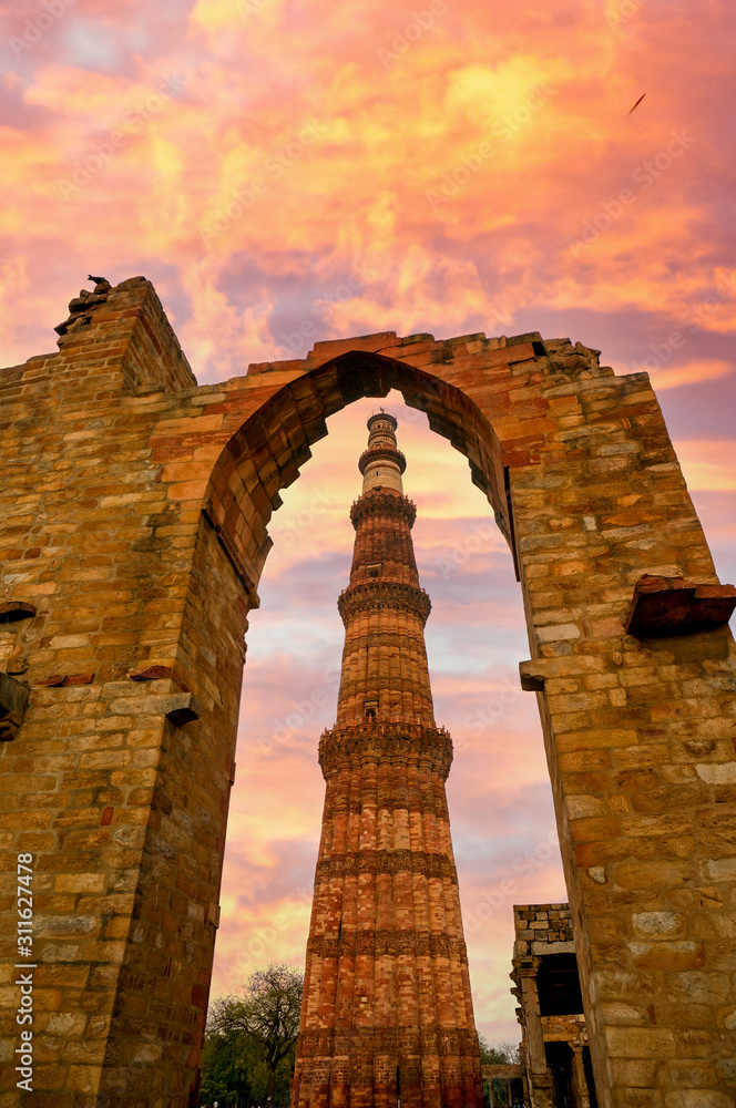 Archway framing the famous landmark the qutub minar in delhi set ...