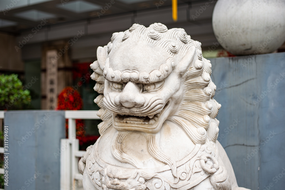 Statue of a Chinese dragon. Head of a lion from white marble, grin ...