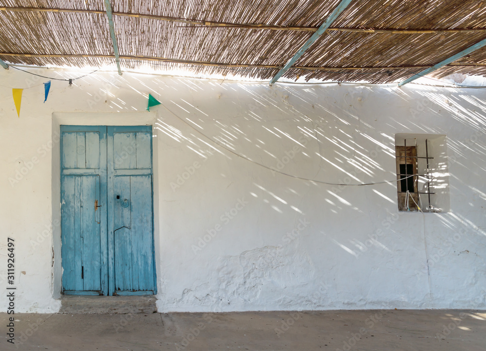 Blue wooden door and small window of abadoned church Ermita de Sant ...
