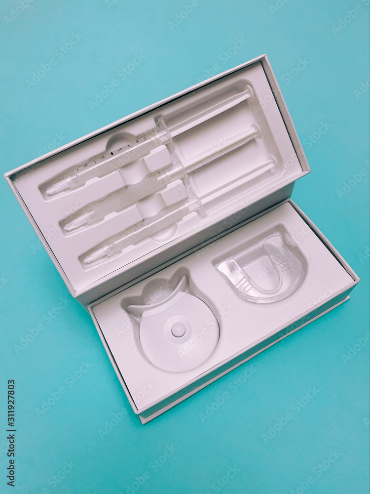 Bleaching set with box isolated on blue background. Home whitening gel ...
