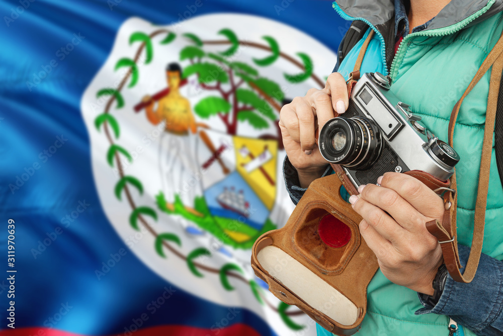 Belize photographer concept. Close-up adult woman holding retro camera ...