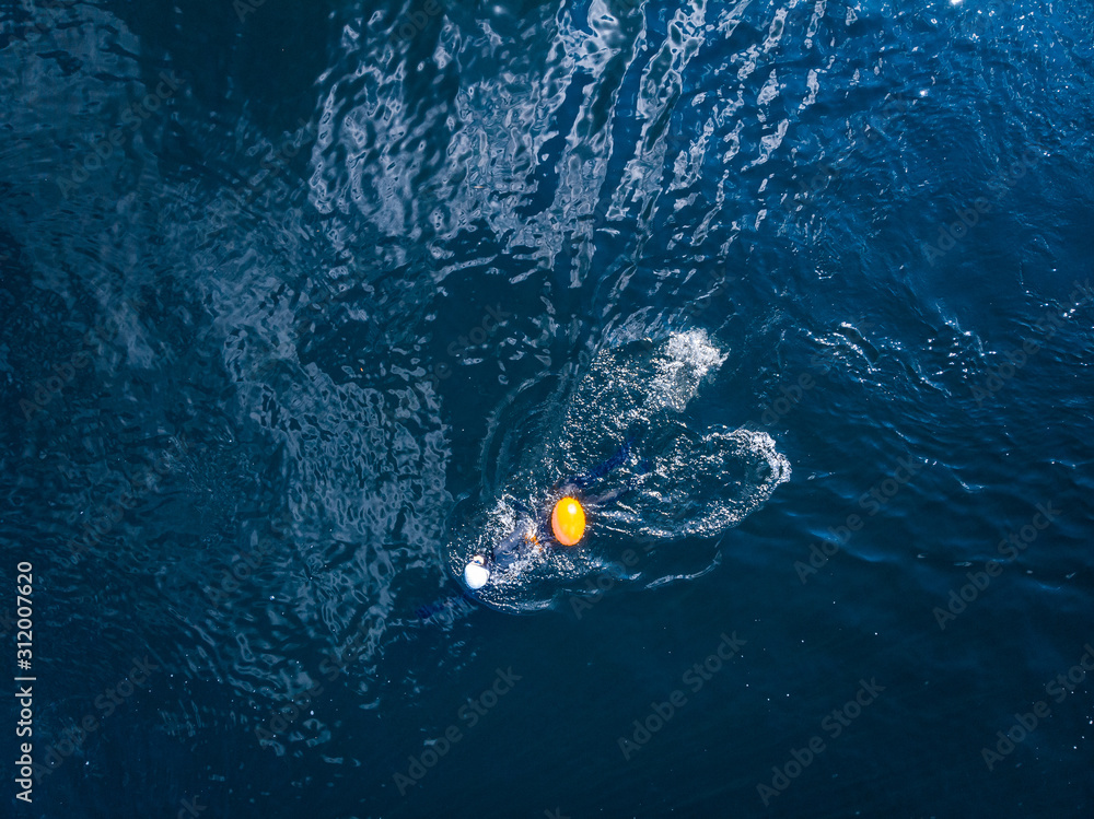 Arctic people swim ice hole in cold water, athletes in wetsuits with ...