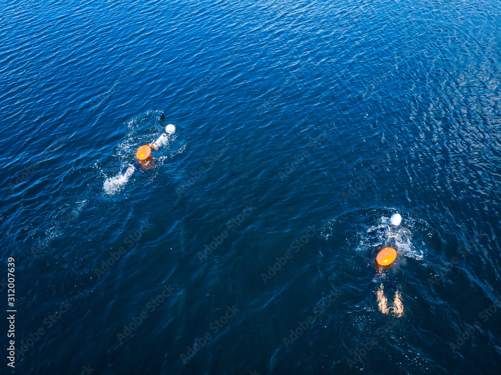 Arctic people swim ice hole in cold water, athletes in wetsuits with ...
