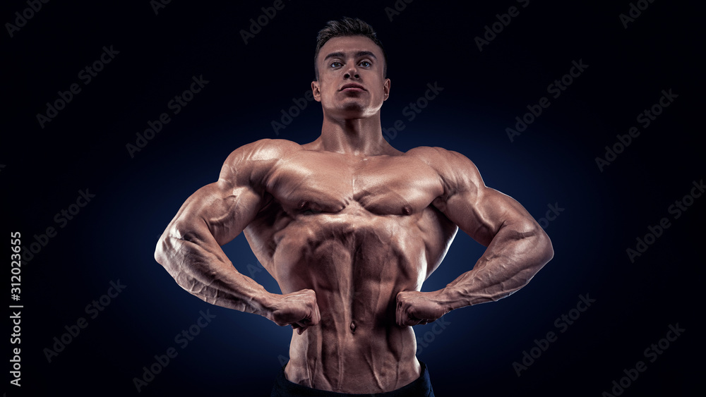Handsome muscular bodybuilder posing on Front Lat Spread display lat ...