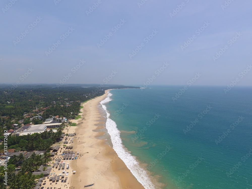 Foto de Stock Beach and palm trees with coconuts on beach in Hikkaduwa ...