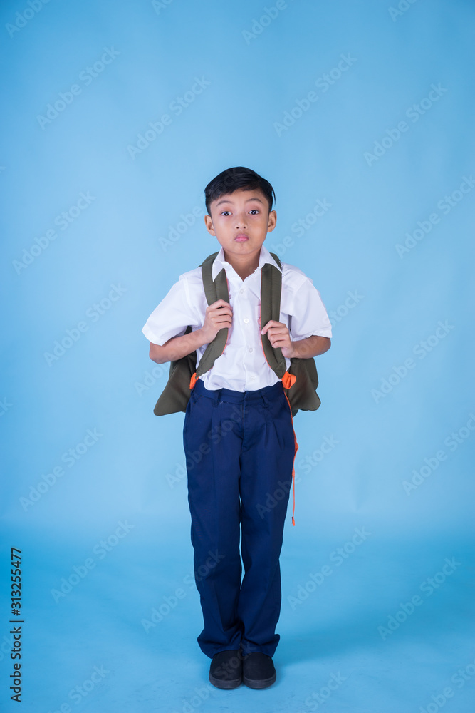 An Asian Muslim school boy wearing white shirt, blue pants school ...
