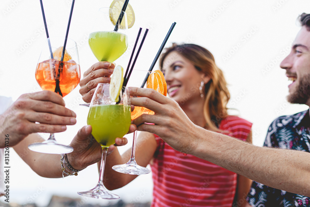 Group of friends enjoying alcoholic cocktails in american bar - Young ...