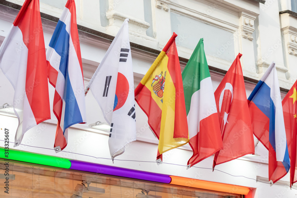 Many national flags of different states countries hang on historical ...