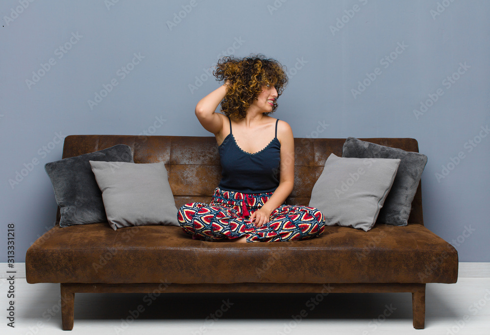 young pretty woman thinking or doubting, scratching head, feeling ...