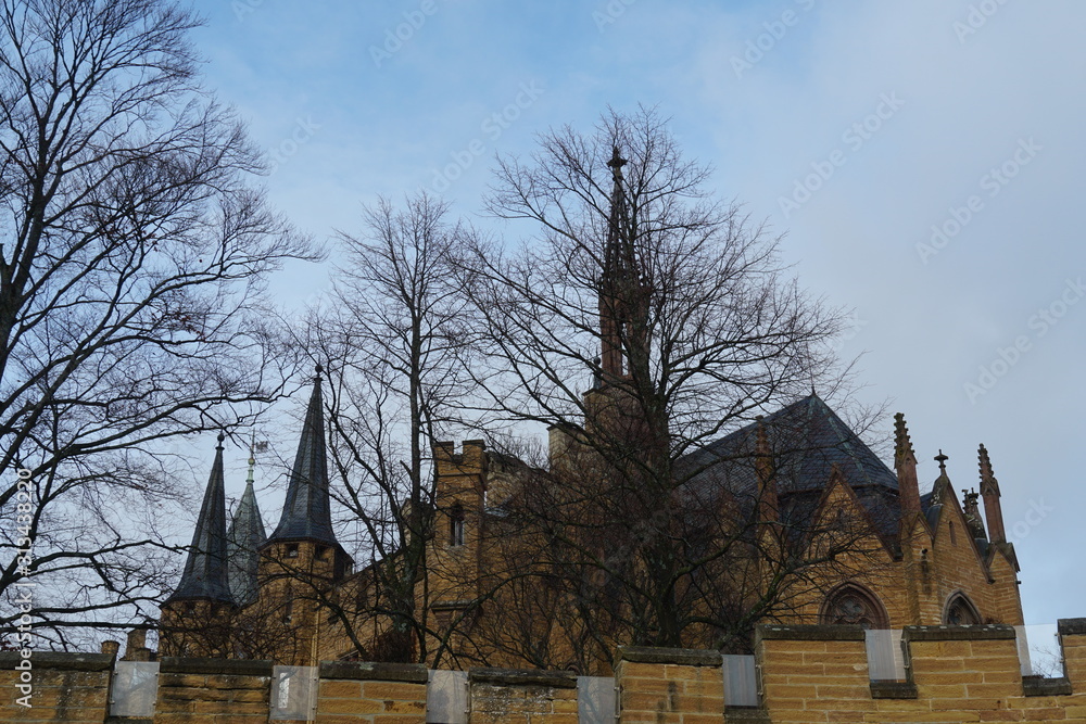 Hohenzollern castle from outside walls hidden behind the trees in ...