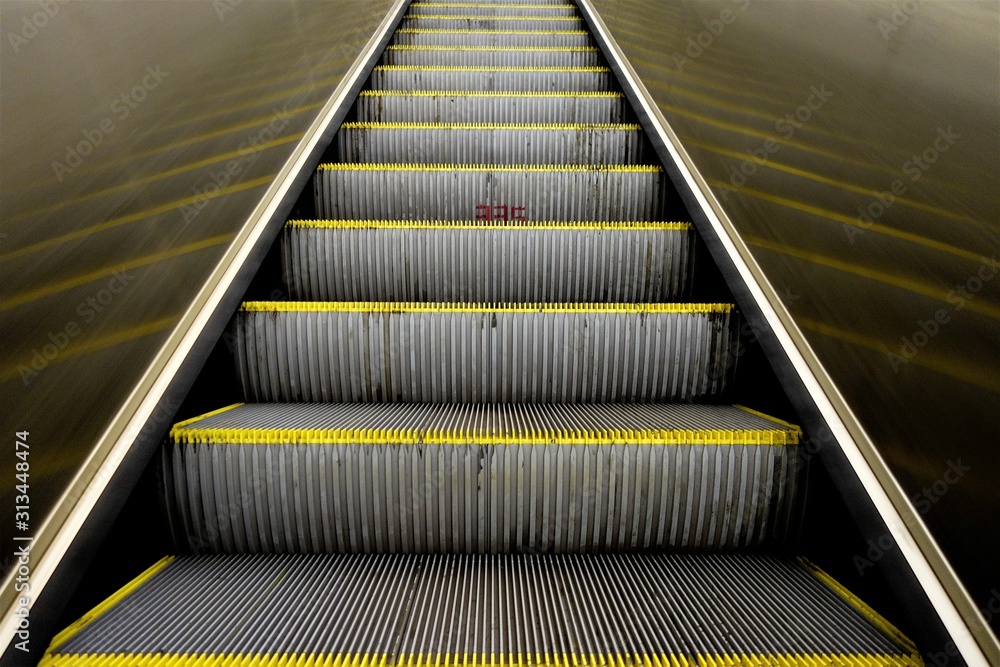 Metal escalator steps with yellow accents Stock Photo | Adobe Stock