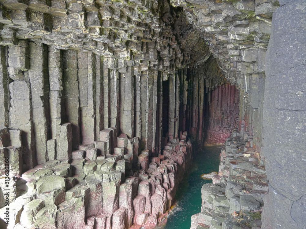 Columns of jointed volcanic basalt rocks in Fingal's Cave in which the ...