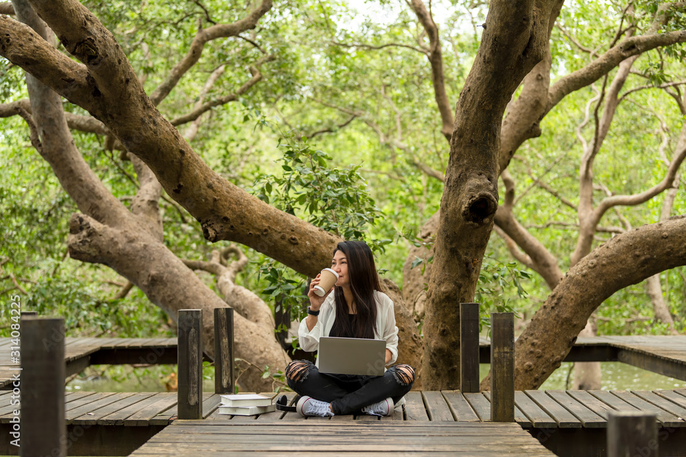 Asian women working and drinking coffee after education nature and ...