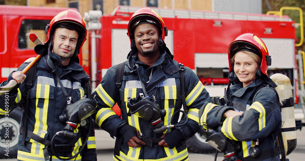 Foto de Stock Portrait of group firefighters standing near fire truck ...