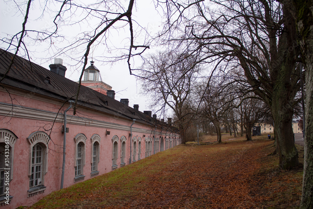 Ancient historical fortification wall with a lighthouse tower above the ...