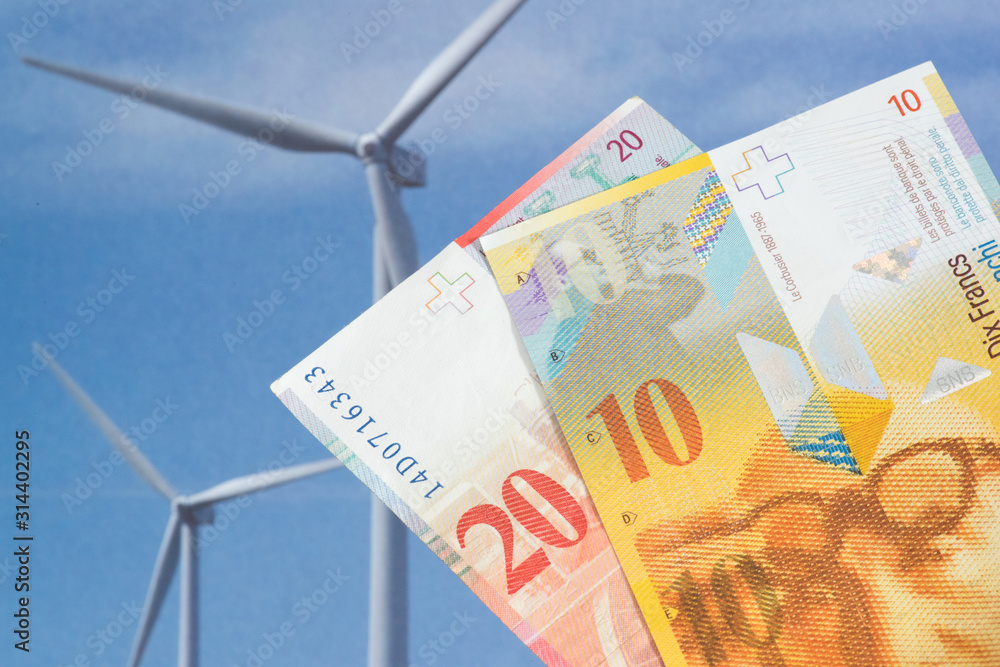 Ein Windrad und Banknoten Schweizer Franken Stock Photo | Adobe Stock