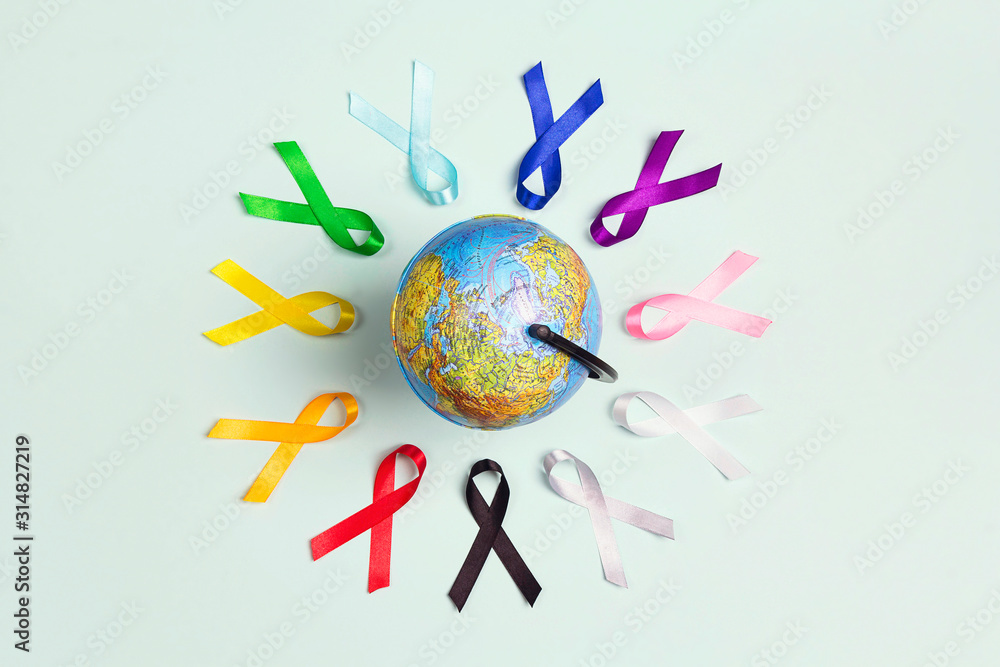 Foto The globe with circle of colorful awareness ribbons on blue ...