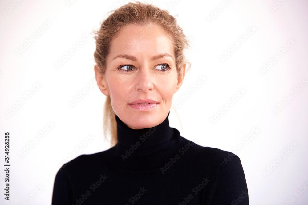 Portrait shot of attractive middle aged woman looking thoughtfully ...