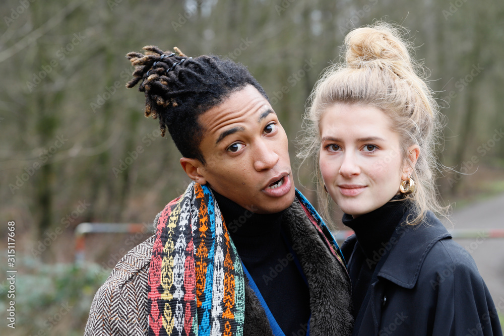 Young intercultural caucasian-hispanic student couple posing during a ...