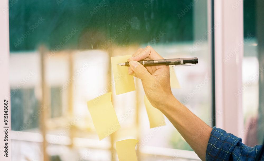 Business people meeting at office and use post it notes to share idea ...