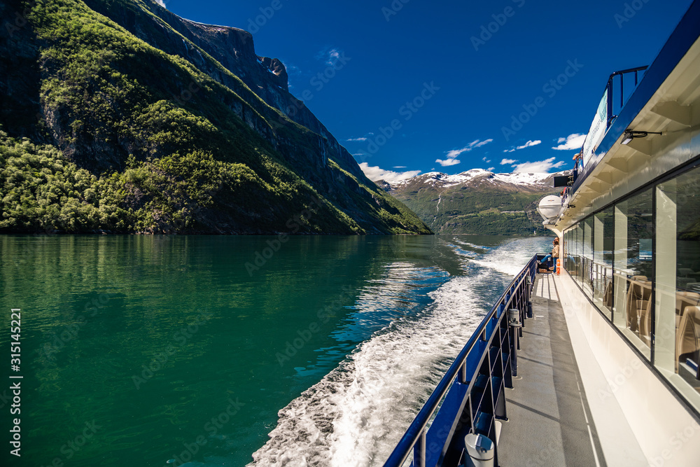 Geiranger, Norway - June, 2019: Ferry sailing on the Geirangerfjord ...