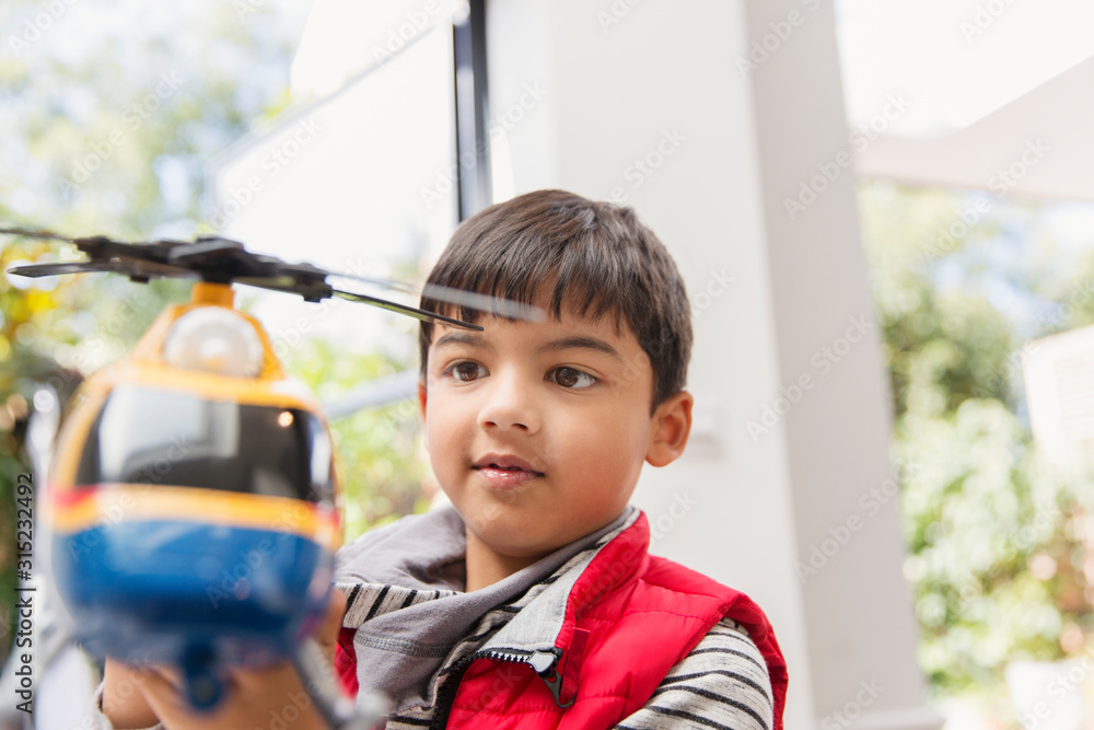 Boy playing with toy helicopter Stock Photo | Adobe Stock