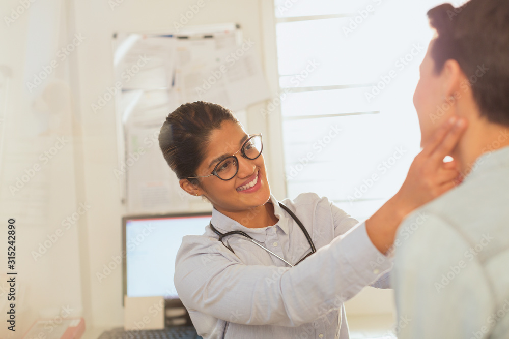 Female doctor checking neck lymph node glands of patient in examination ...