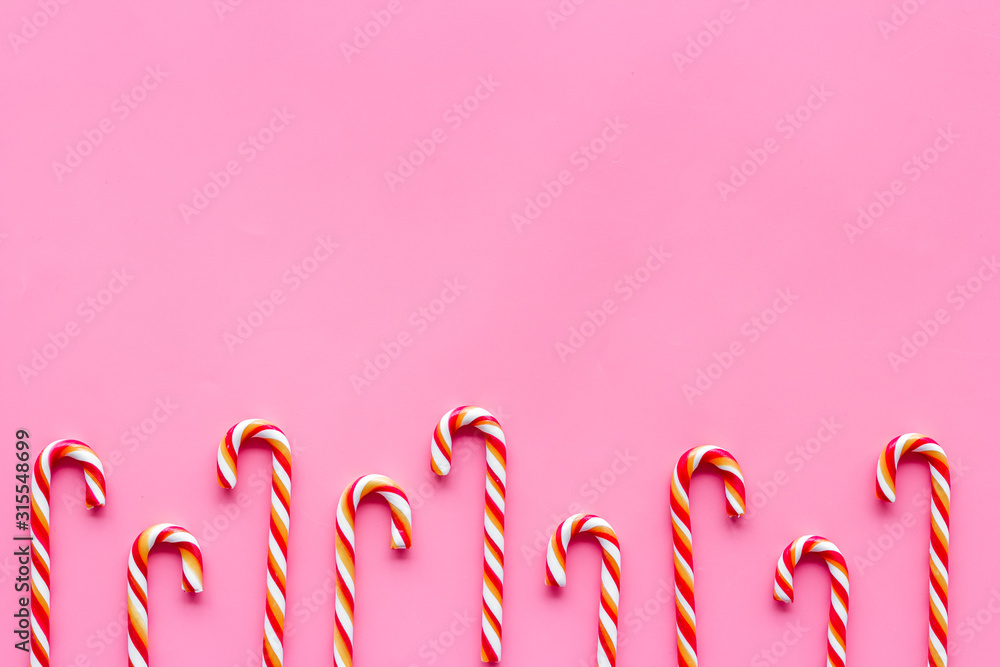 Christmas candies frame - cane with red and white stripes - on pink ...