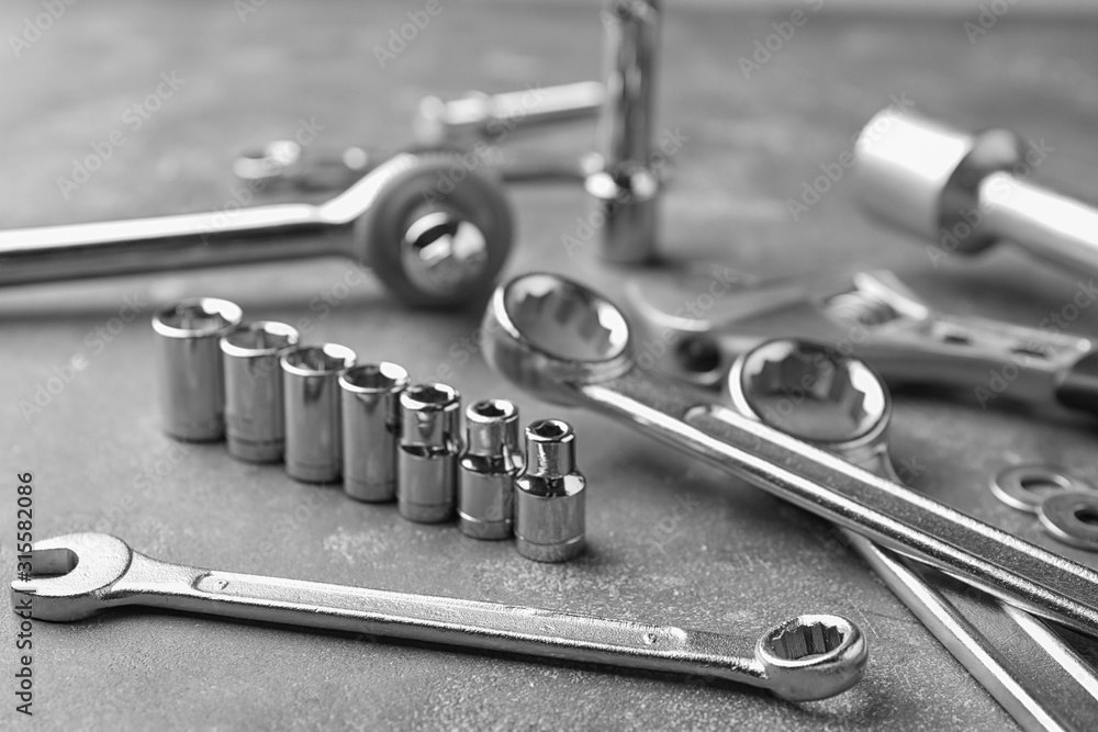 Auto mechanic's tools on grey stone table Stock Photo | Adobe Stock