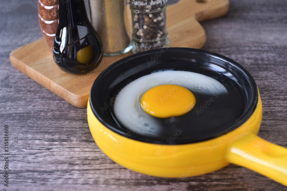 Egg yolk and egg white on fried egg is cooked from the heat of the ...