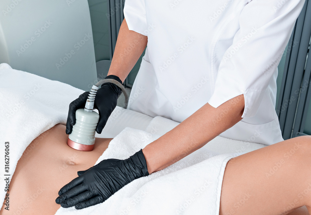 Ultrasound cavitation body contouring treatment. Woman getting anti ...