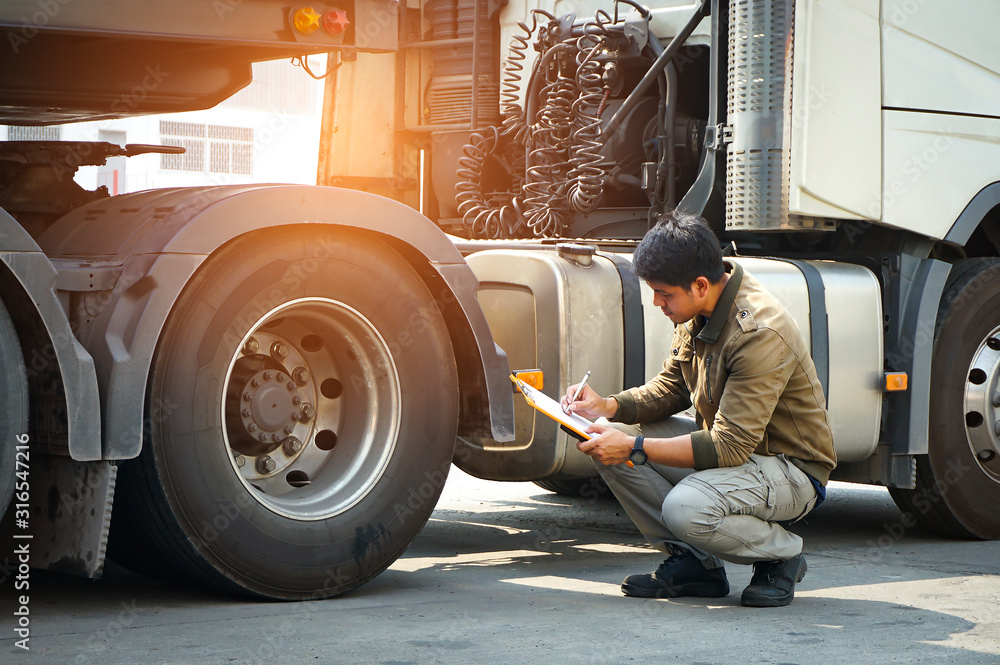 Auto Mechanic is Checking the Truck's Safety Maintenance Checklist ...