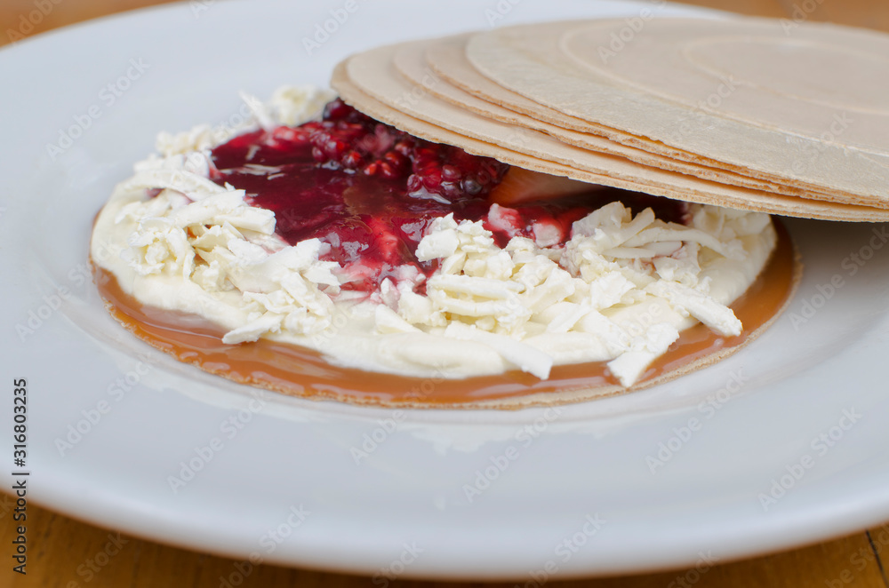 Wafer, traditional Colombian dessert, chopped fruit cookie and sauces ...