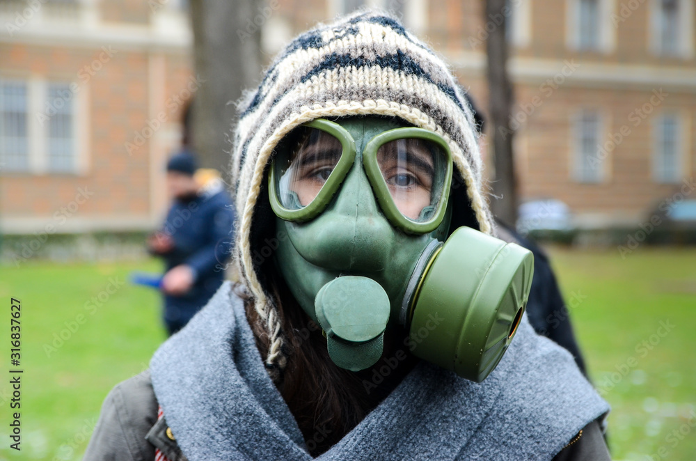 Girl wearing military gas mask. Protection from air pollution, gas ...