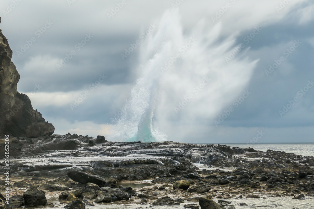 Tall and strong waves crushing over the sharp cliffs of Koka Beach ...