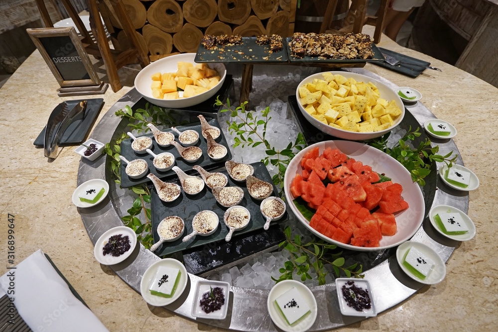 Buffet bar station of assorted fruits and desserts- watermelon ...