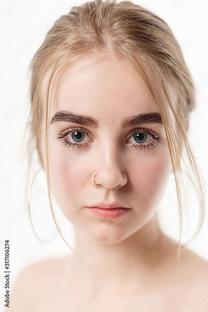 Beauty portrait of young attractive half naked teenage girl with perfect skin looking at camera ...