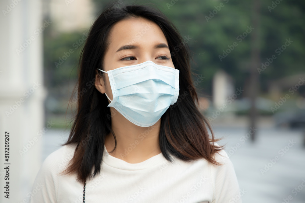 woman wearing mask in city with dirty polluted poison smog; concept of ...