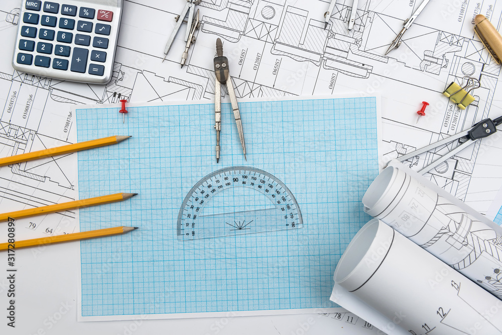 Technical drawing, graph paper and tools. Engineer office team working ...
