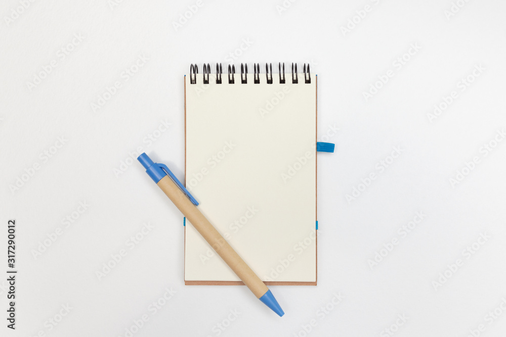 Eco notebook with recycled pen on a white background with copy space ...