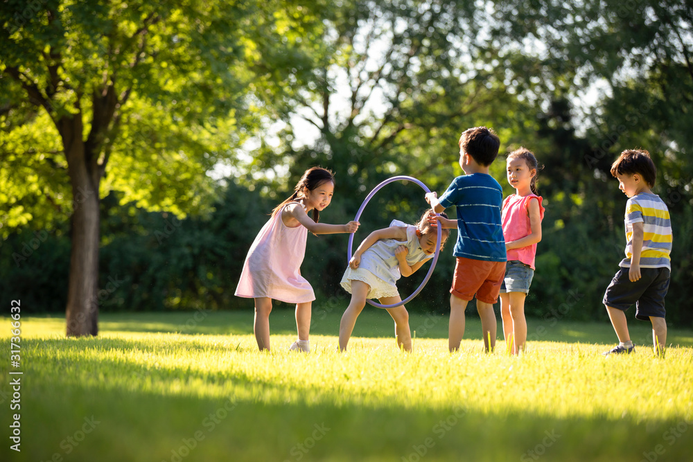 Happy children playing on meadow Stock Photo | Adobe Stock