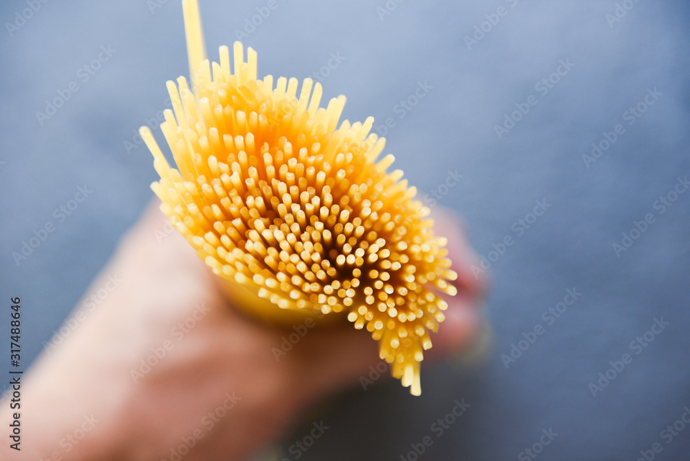 Man holding raw spaghetti italian pasta uncooked spaghetti yellow long ...